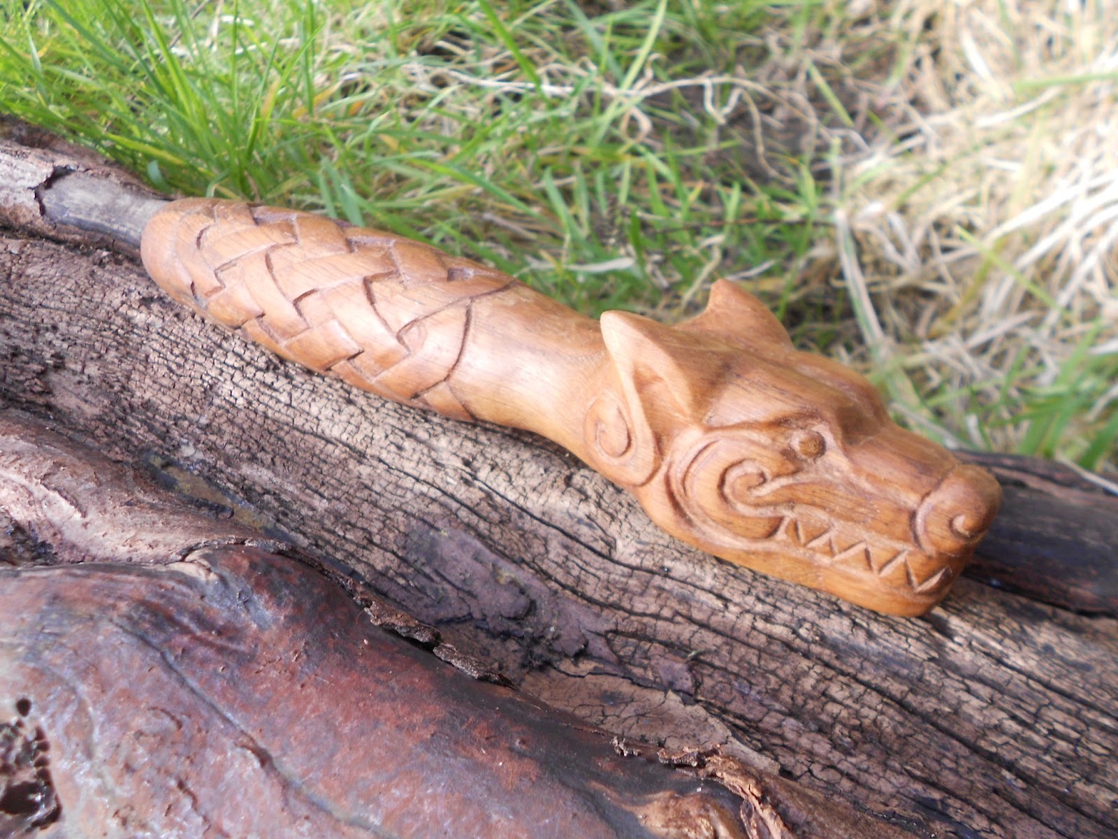 A pagan ritual knife handle, carved in oak with a Viking-style wolf's ...