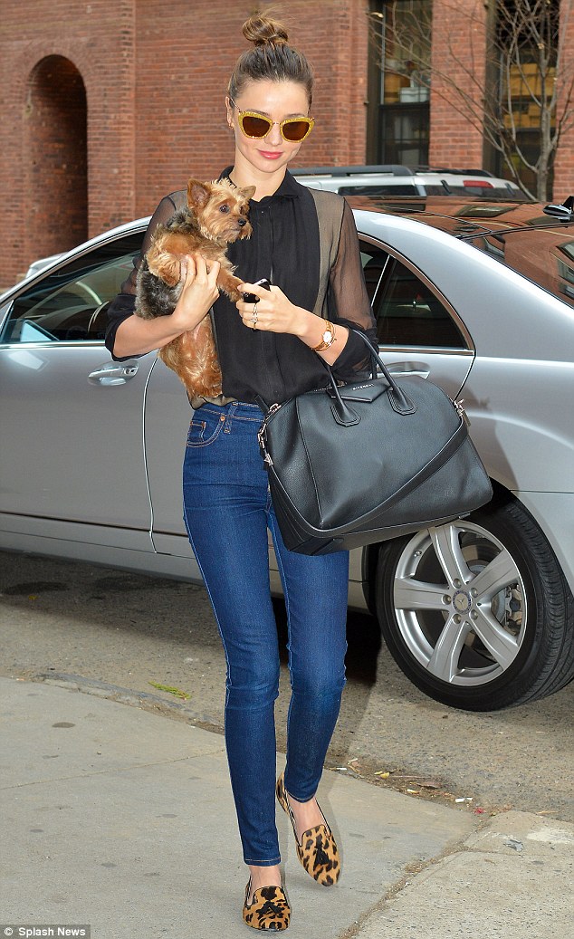 Miranda Kerr flaunts a Givenchy tote and gold glitter rimmed shades in ...