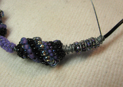 A wire bracelet featuring beaded beads