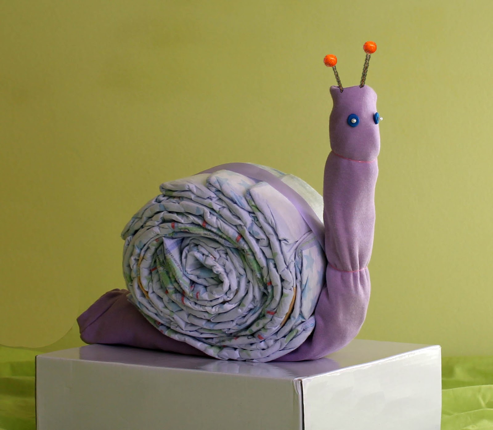 Los mil y un pañales. Regalos originales para bebés.: Diseño de Caracol