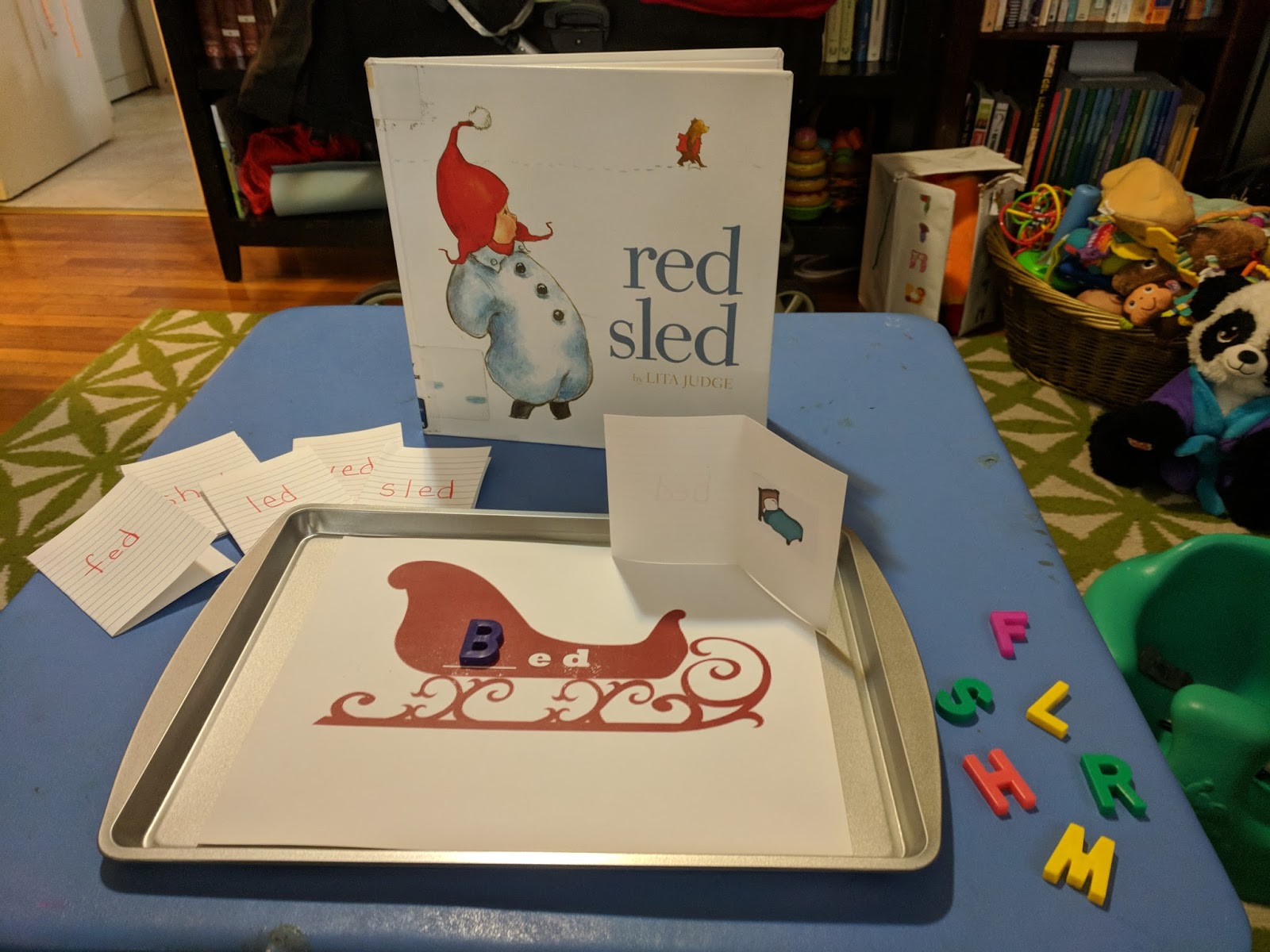 In Praise of Play: Beyond the Book: red sled by Lita Judge