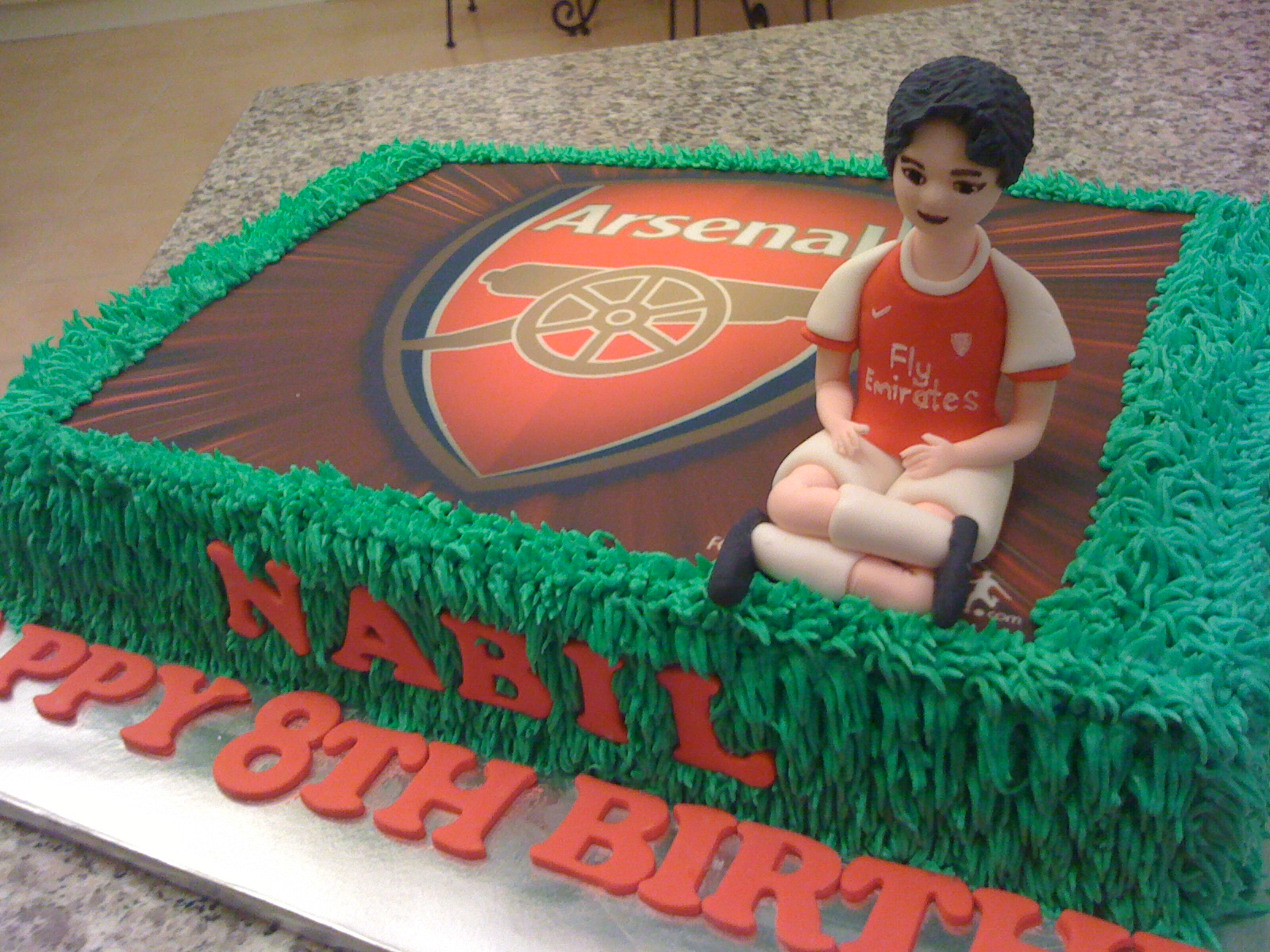 CAKE CUPBOARD: Arsenal football cake with a figurine