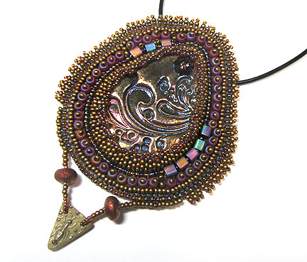 Floral swirl and ant bead embroidered pendant