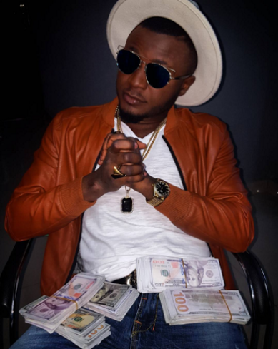 Singer MC Galaxy pose with wads of foreign currency