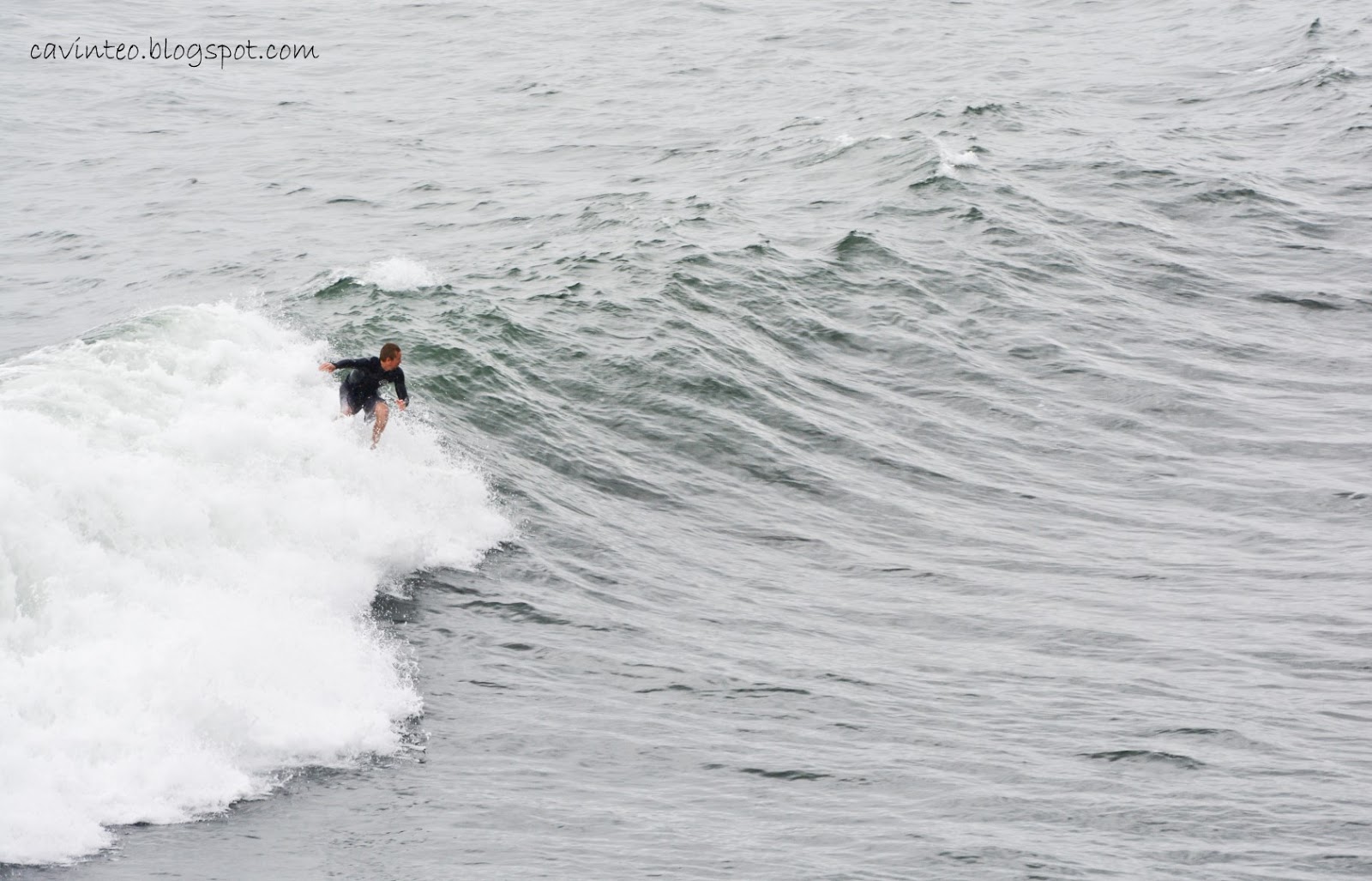 Entree Kibbles: Surfers Surfing on Choppy Waters at Tanah Lot in Bali ...