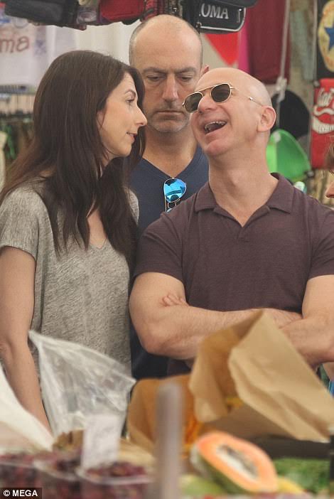 Billionaire Amazon founder, Jeff Bezos wraps his arm around his wife as ...