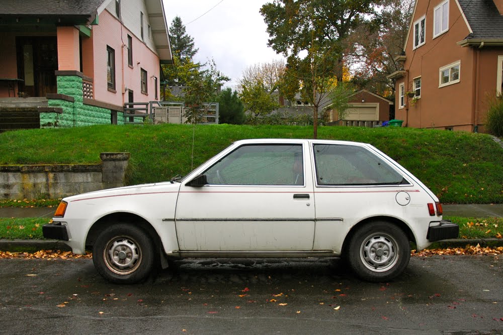 OLD PARKED CARS.: 1983 Plymouth Colt.