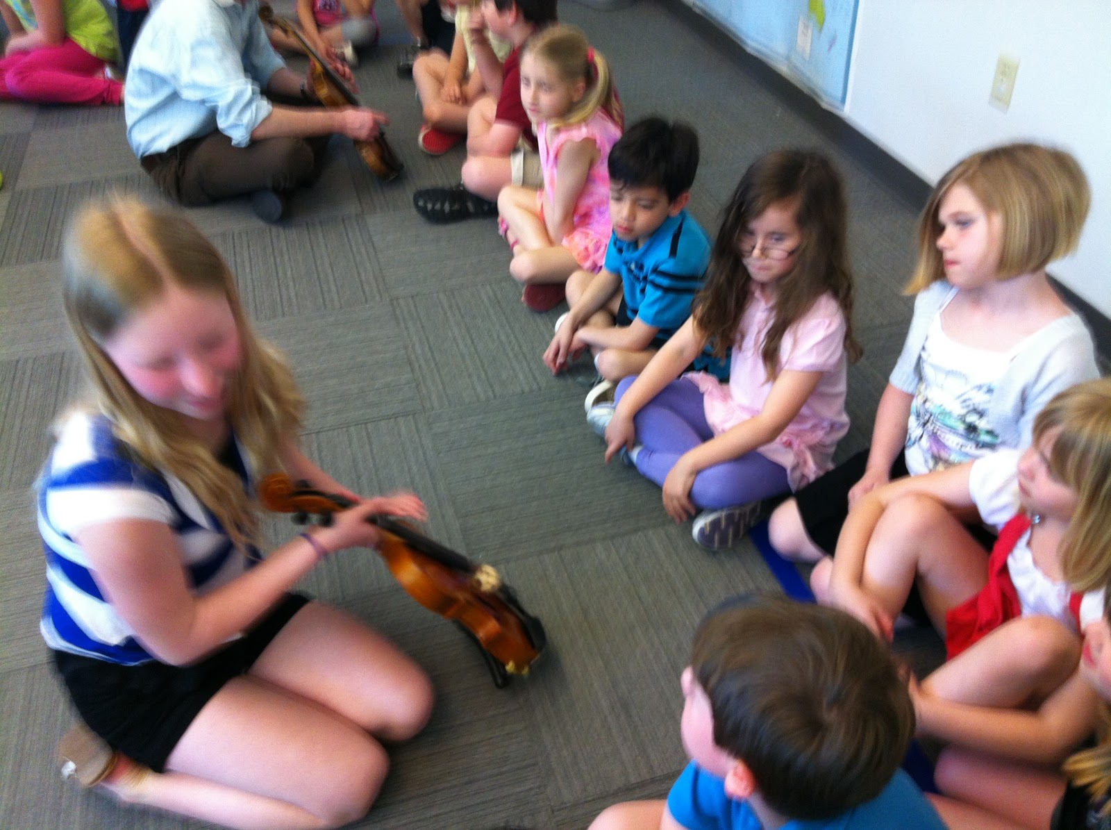 Mrs. Hannah's First Grade Class: 6th grade orchestra play for 1st grade