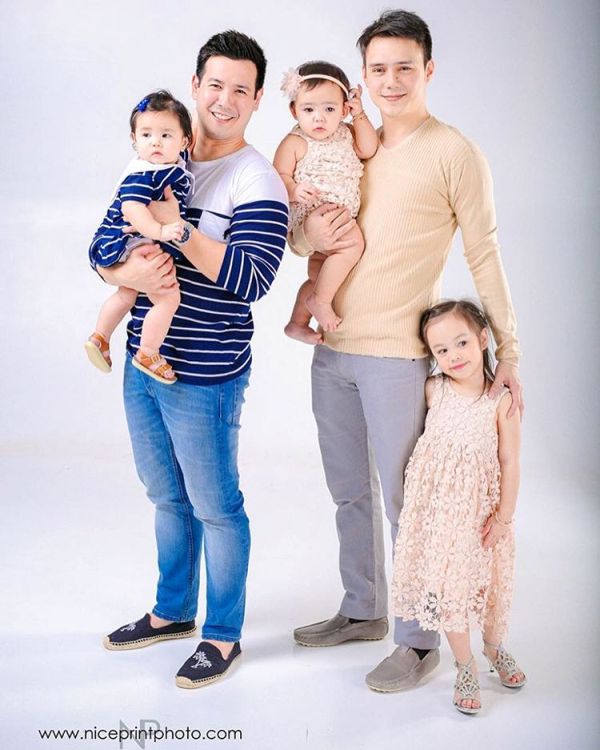 John Prats, Patrick Garcia and their children pose for a photo which ...