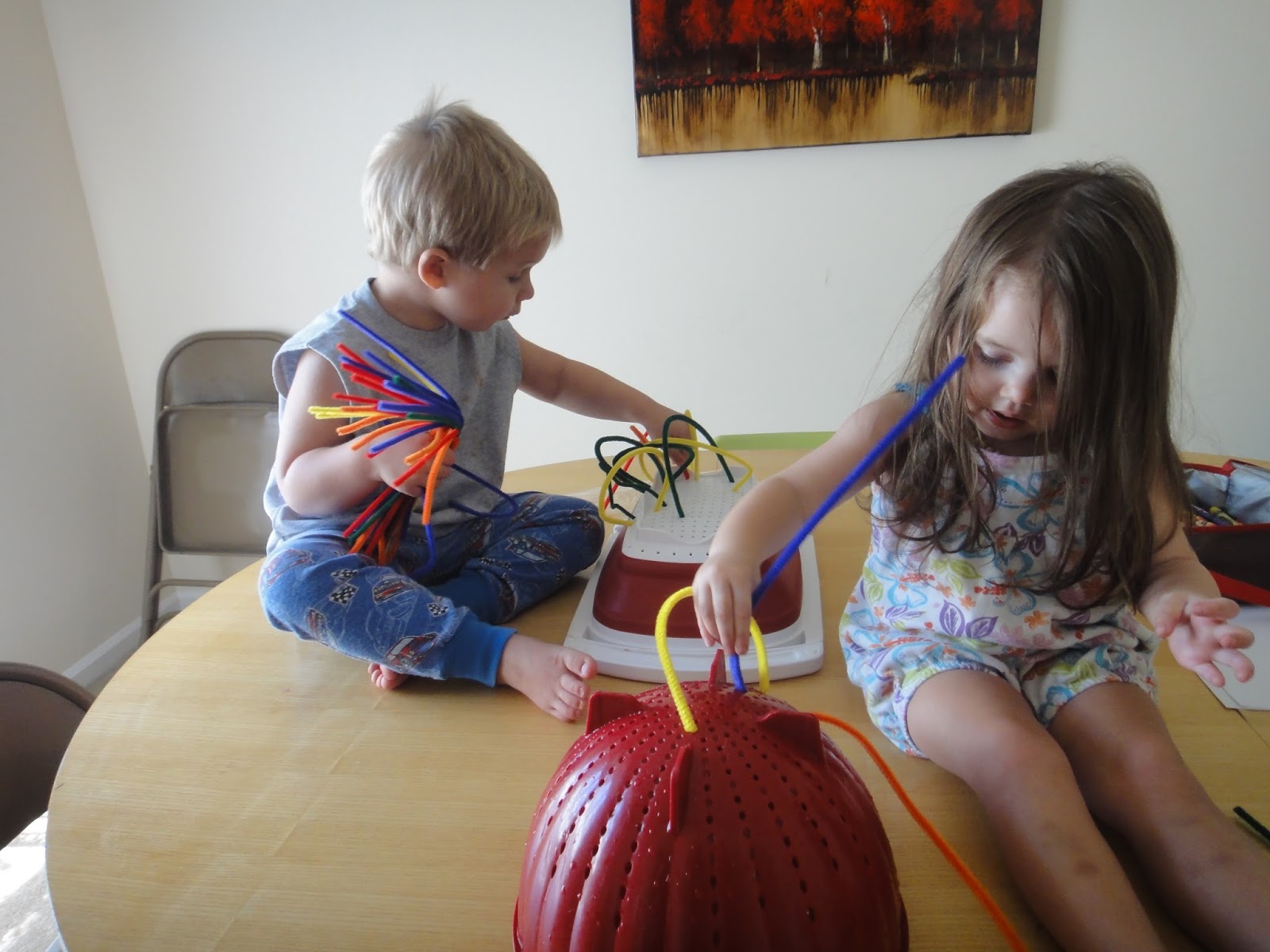 The Inspired Toddler: Making Rainbows: Colanders and Pipe Cleaners