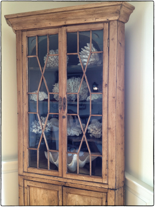 Content in a Cottage: Corner Cupboard Filled with Shells and Coral
