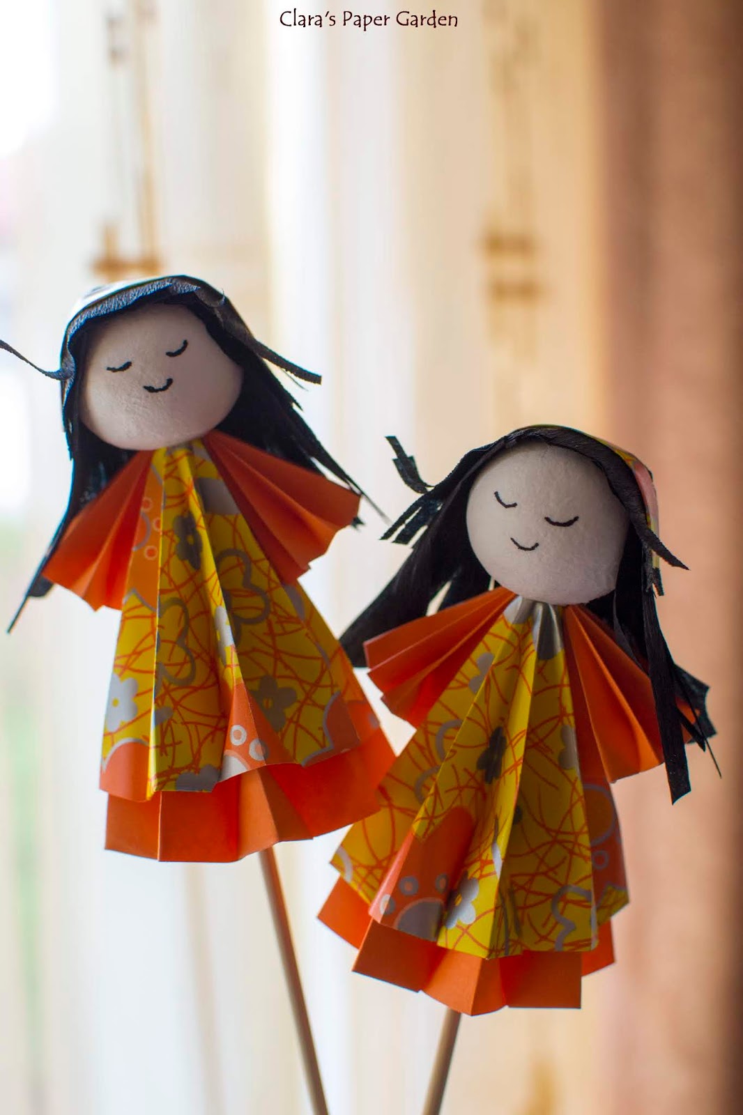 Purple and orange paper dolls