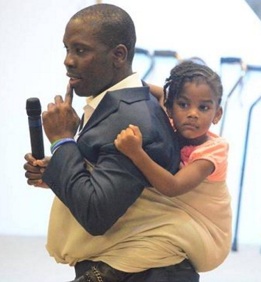 Photos: Nigerian Pastor Carries Baby On His Back While Preaching In ...