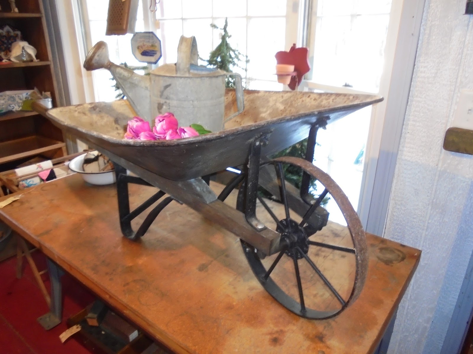 Log Cabin Antiques & Gifts: Old metal wheelbarrow with cast iron wheel