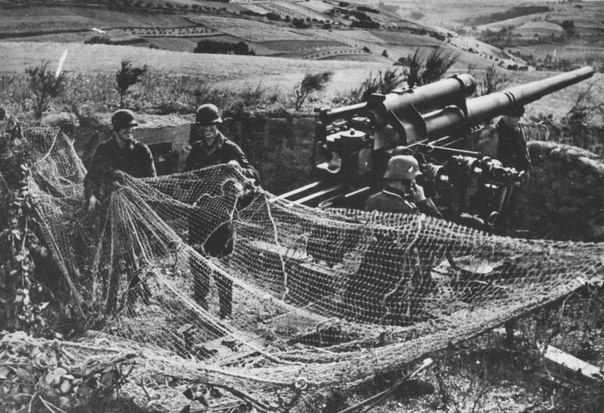 World War II History: Soldiers pull camouflage net on the position of ...