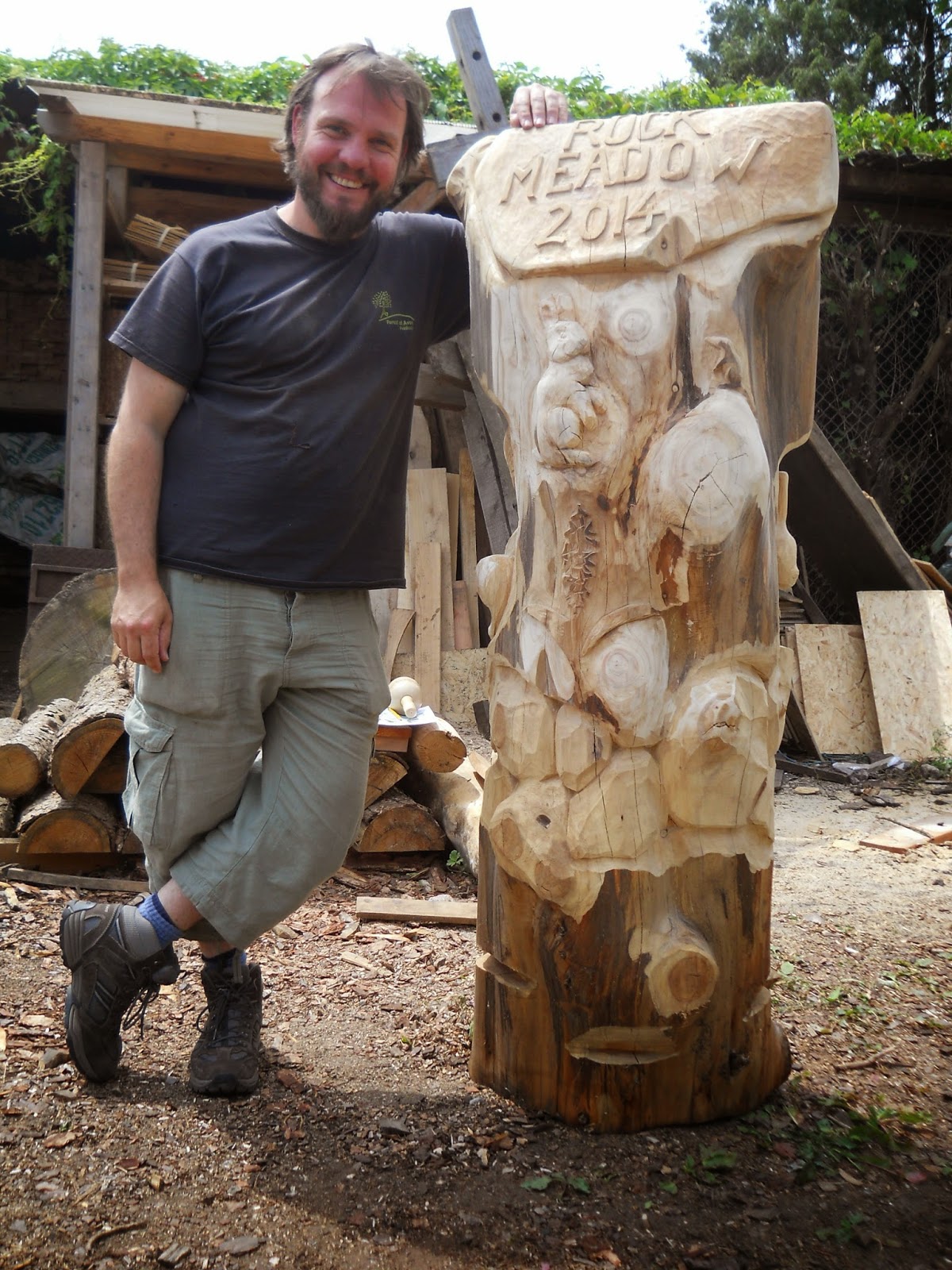 A carved cedar log as a sign for Rock Meadow, a new housing development ...