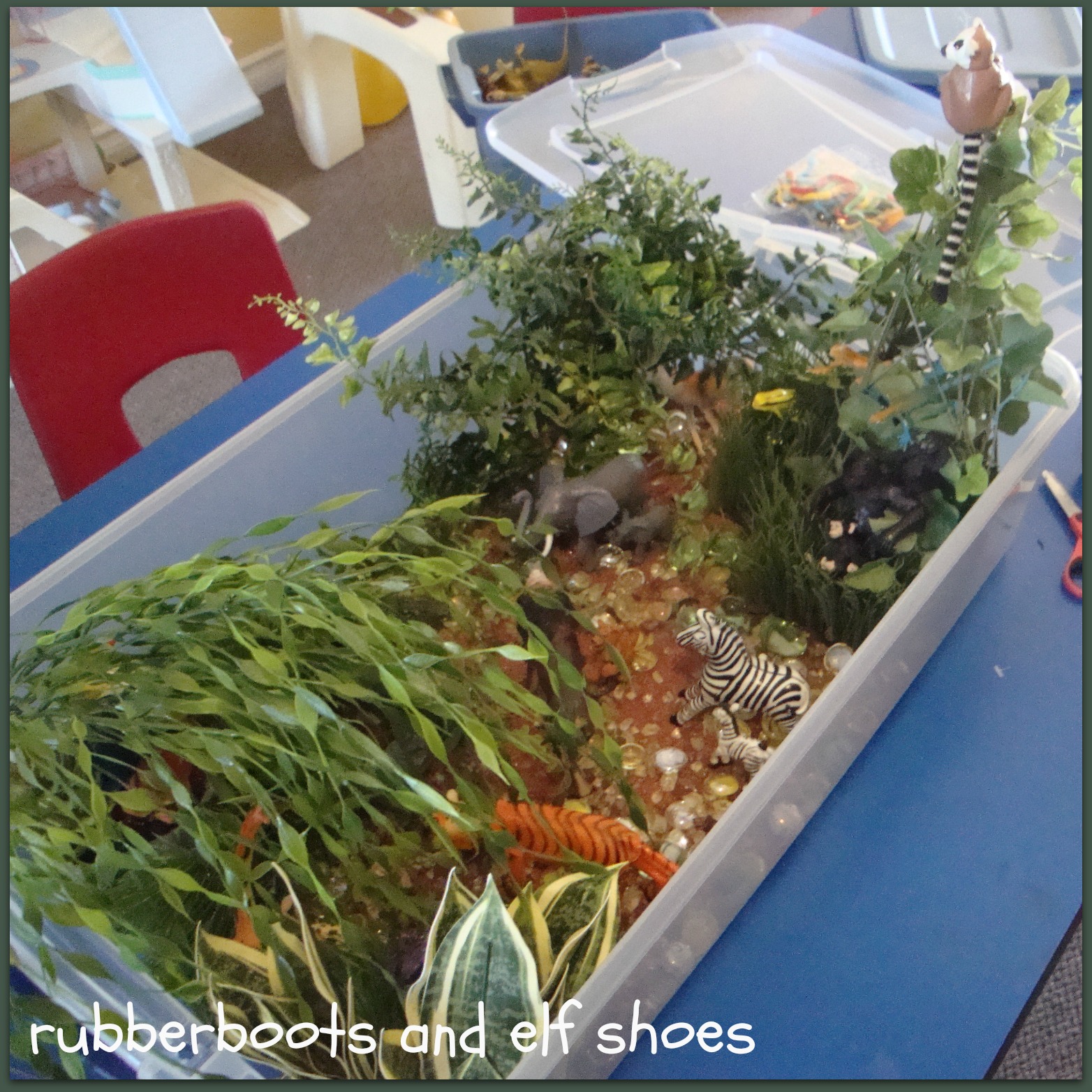 jungle sensory bin - rubber boots and elf shoes