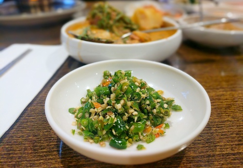 A plate of sliced green peppers arrives on its own, allowing each diner ...