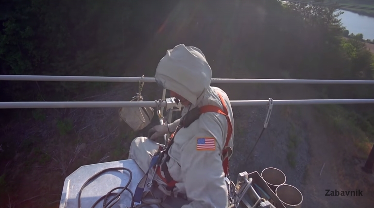 A lineman wearing a Faraday suit can work on live, high-power lines by ...