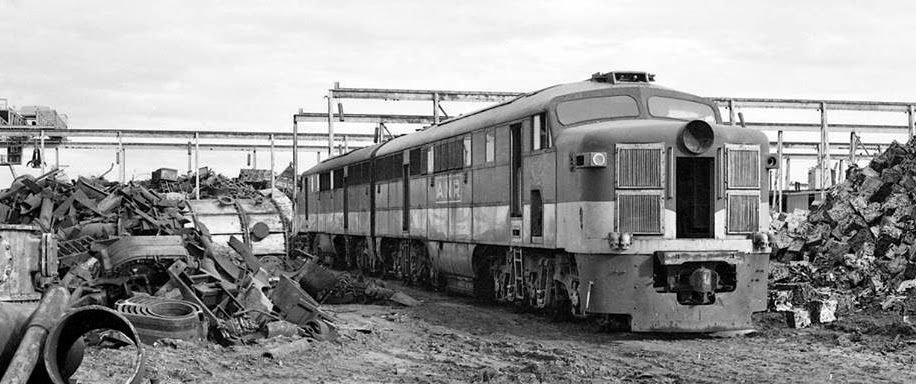 Just A Car Guy: an extremely unusual photo... a train in a salvage yard