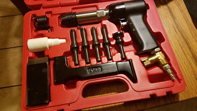 A typical rivet gun and bucking bar set.