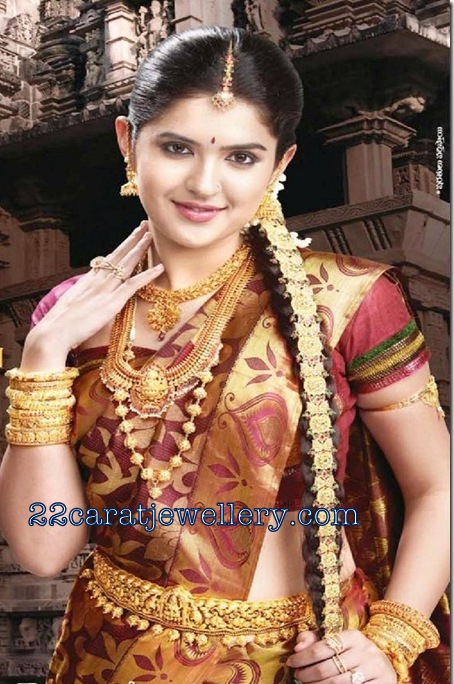 Deeksha Seth in Gold Choti and Oddiyanam - Jewellery Designs