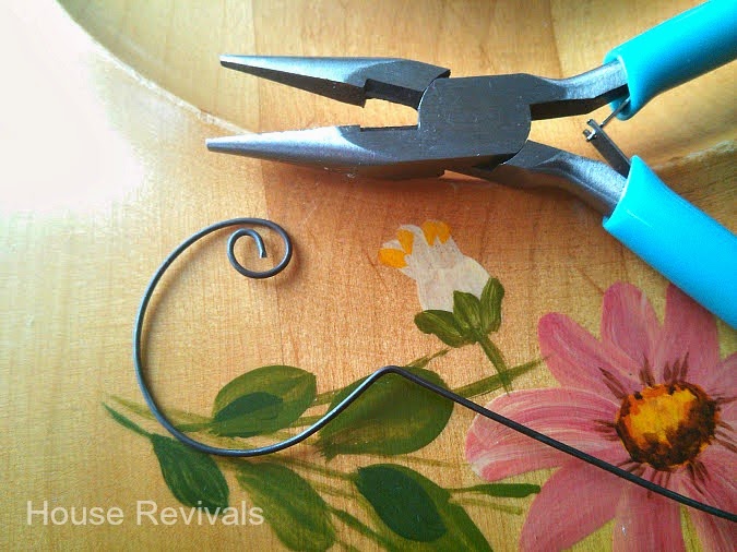 Now remove the wire from the dowel, and use the pliers to create a ...