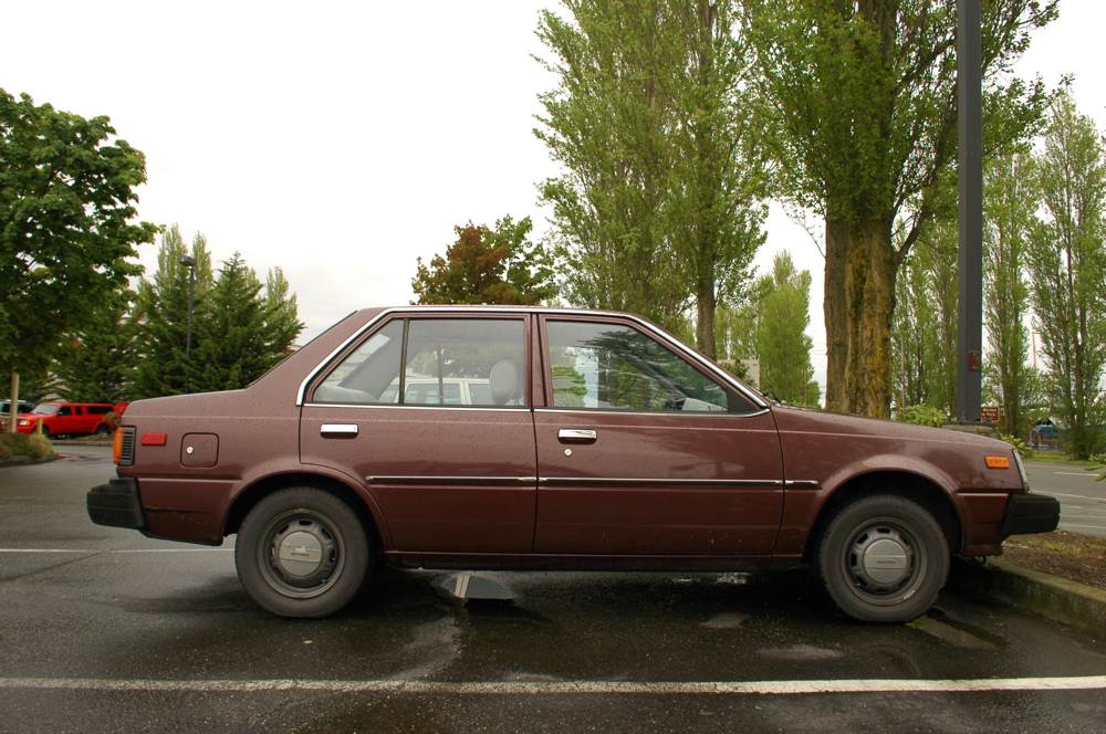 OLD PARKED CARS.: 1982 Datsun/Nissan Sentra Sedan.