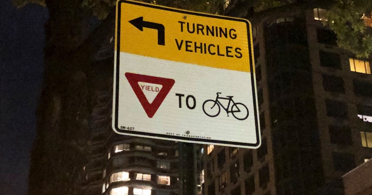 We love Reading Street Signs: Left Turning Vehicles Yield to Bikes Sign
