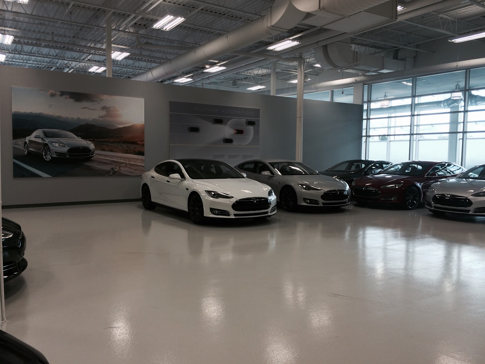 Enjoying a big gulp of free juice at the largest Tesla dealership in ...