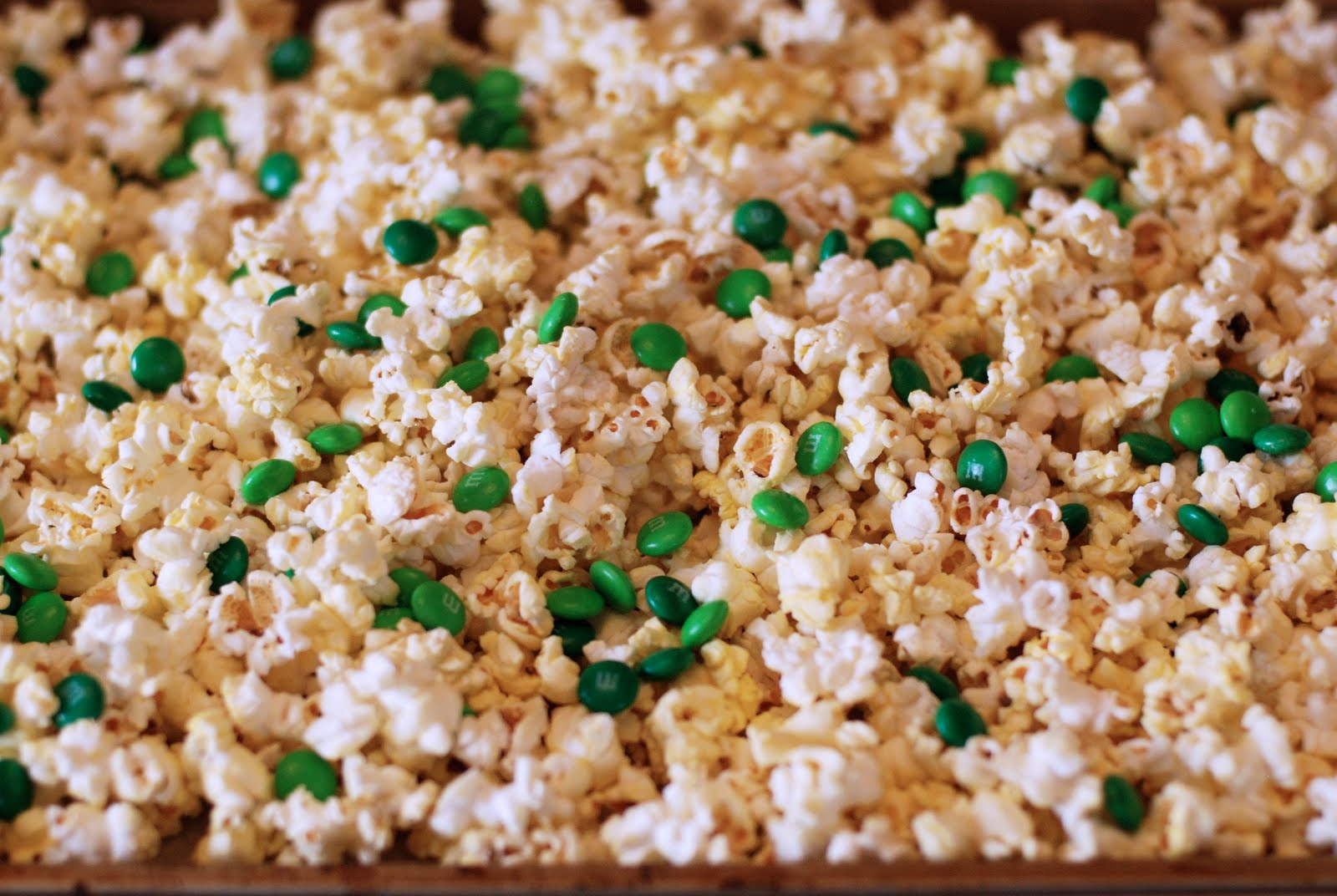 Once your popcorn has been popped, spread it on a baking sheet lined ...