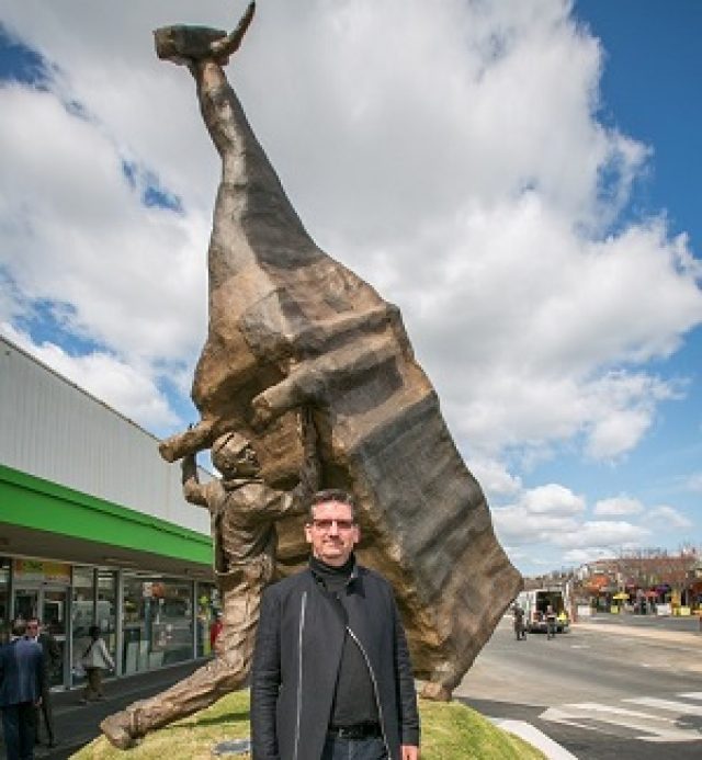 The Holiday and Travel Magazine: Man Lifting Cow