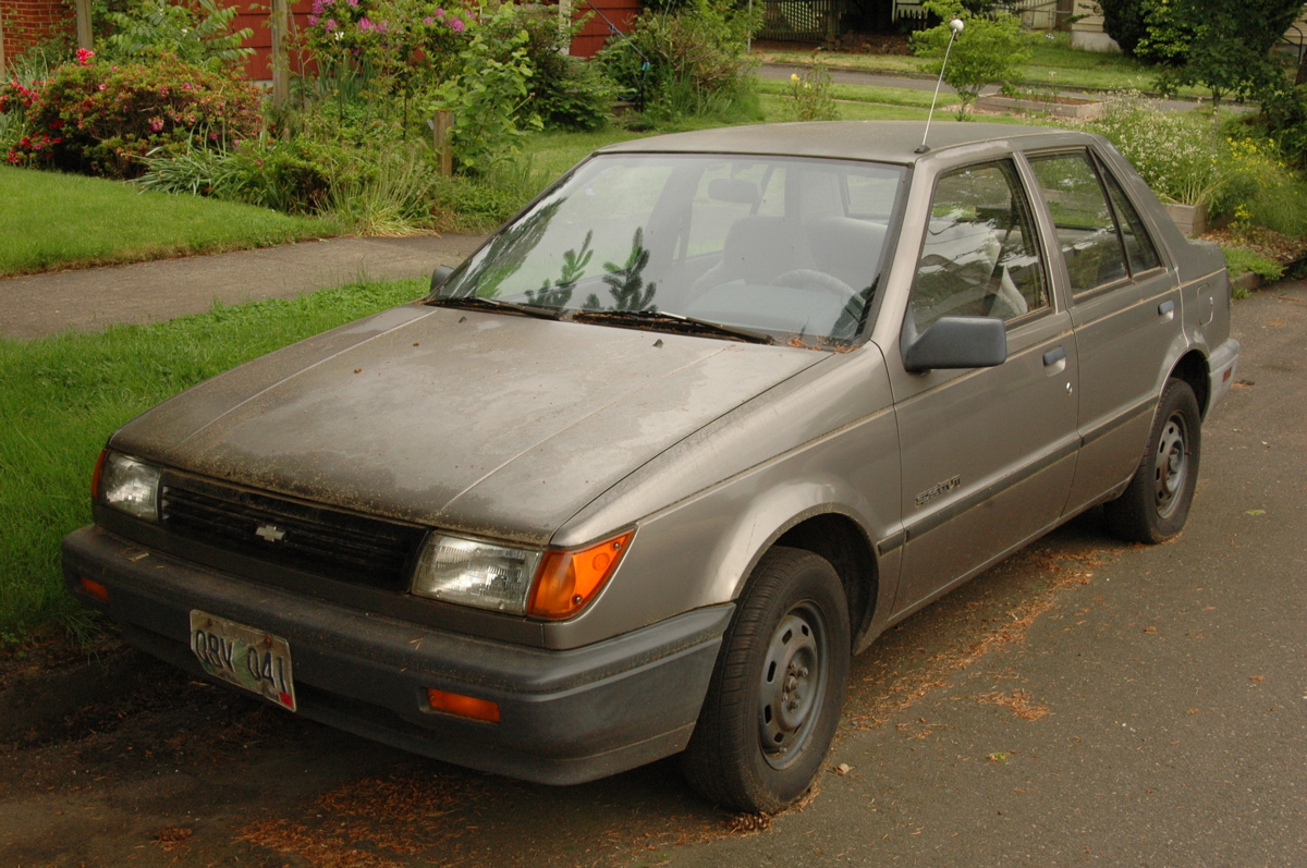 OLD PARKED CARS.: 1989 Geo Spectrum.