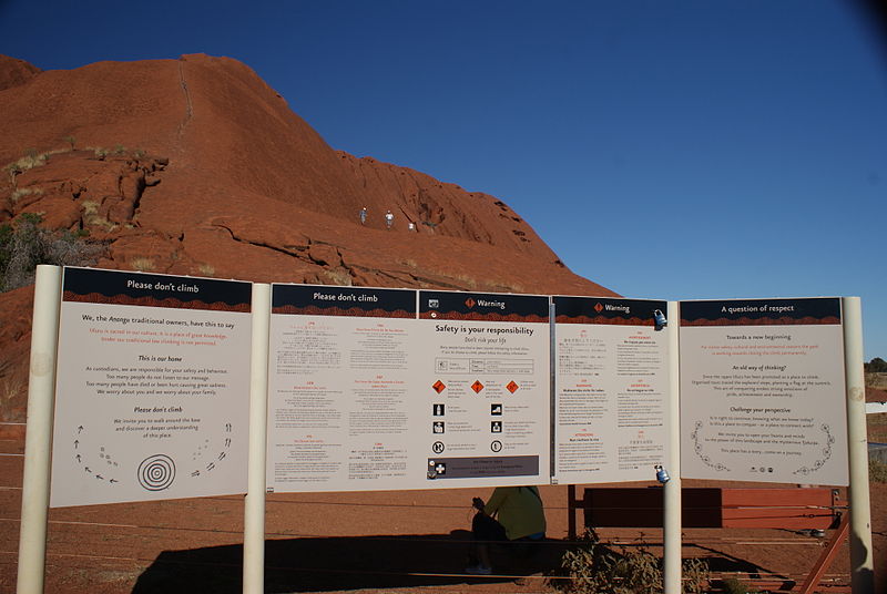 Pictorial history of warning signs at the base of the climb at Ayers Rock