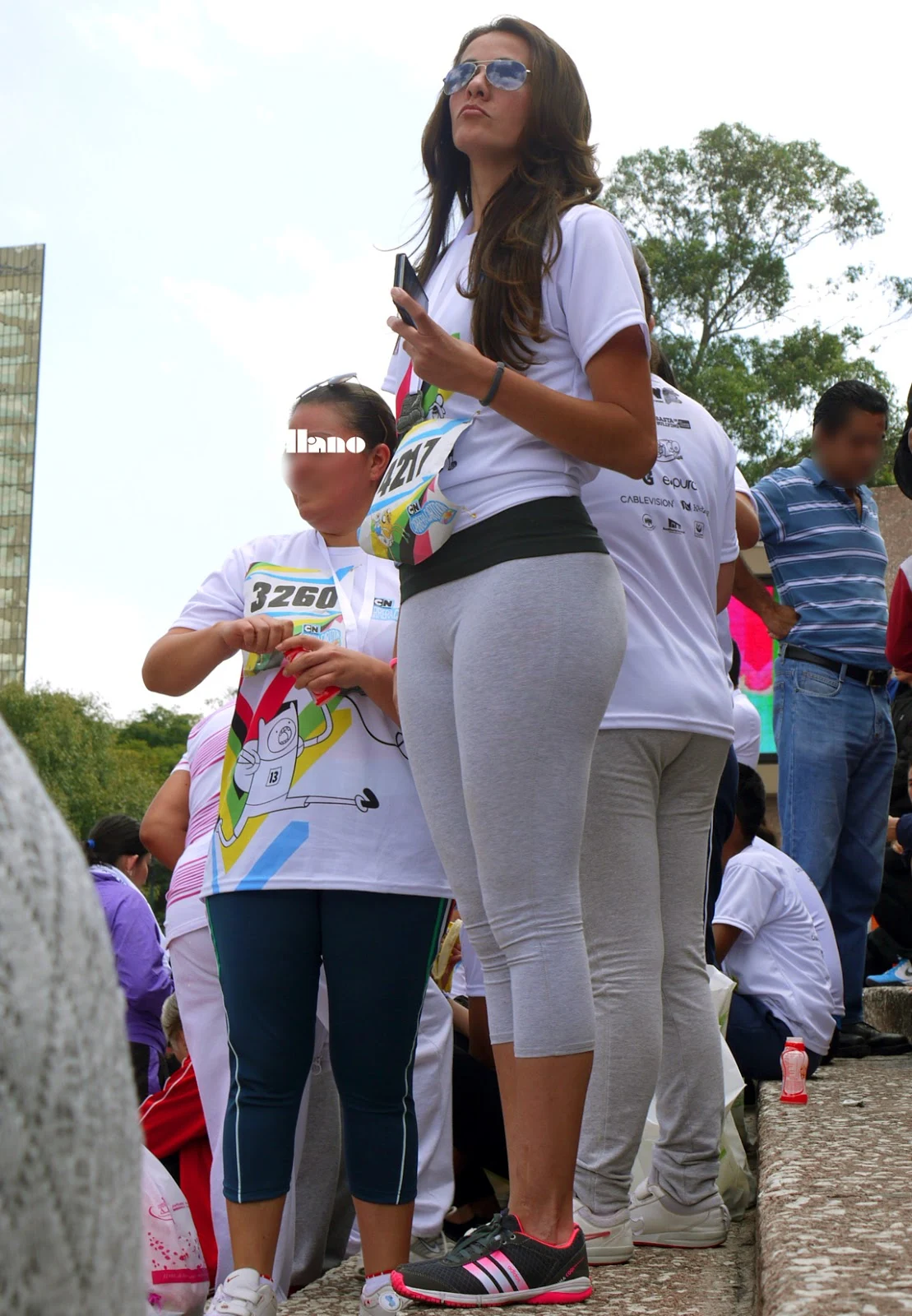 Pretty brunette in tight gray leggings showing round ass