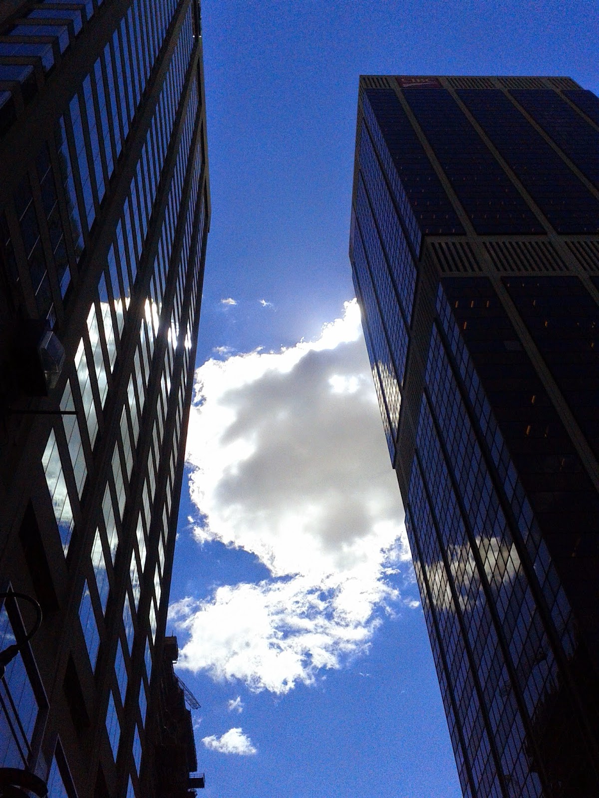 Toronto things: Stock photo: Blue sky and clouds in between buildings ...