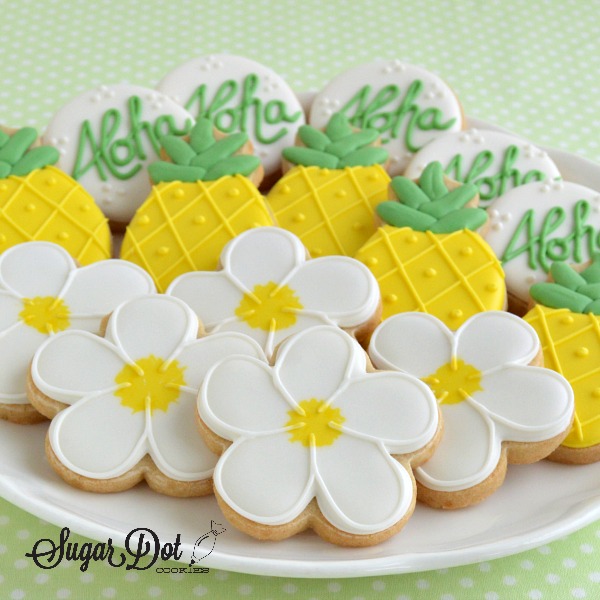 Pineapples, tropical flowers, and "Aloha" on small rounds.