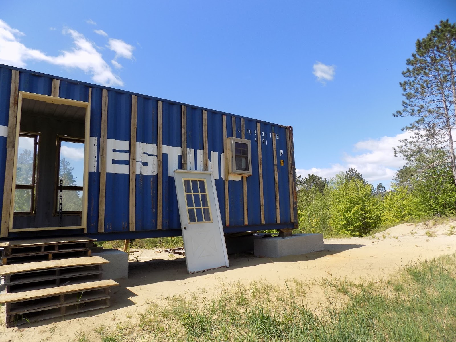 Intermodal House: Strapping on, Windows in, Insulation, Siding Mostly on