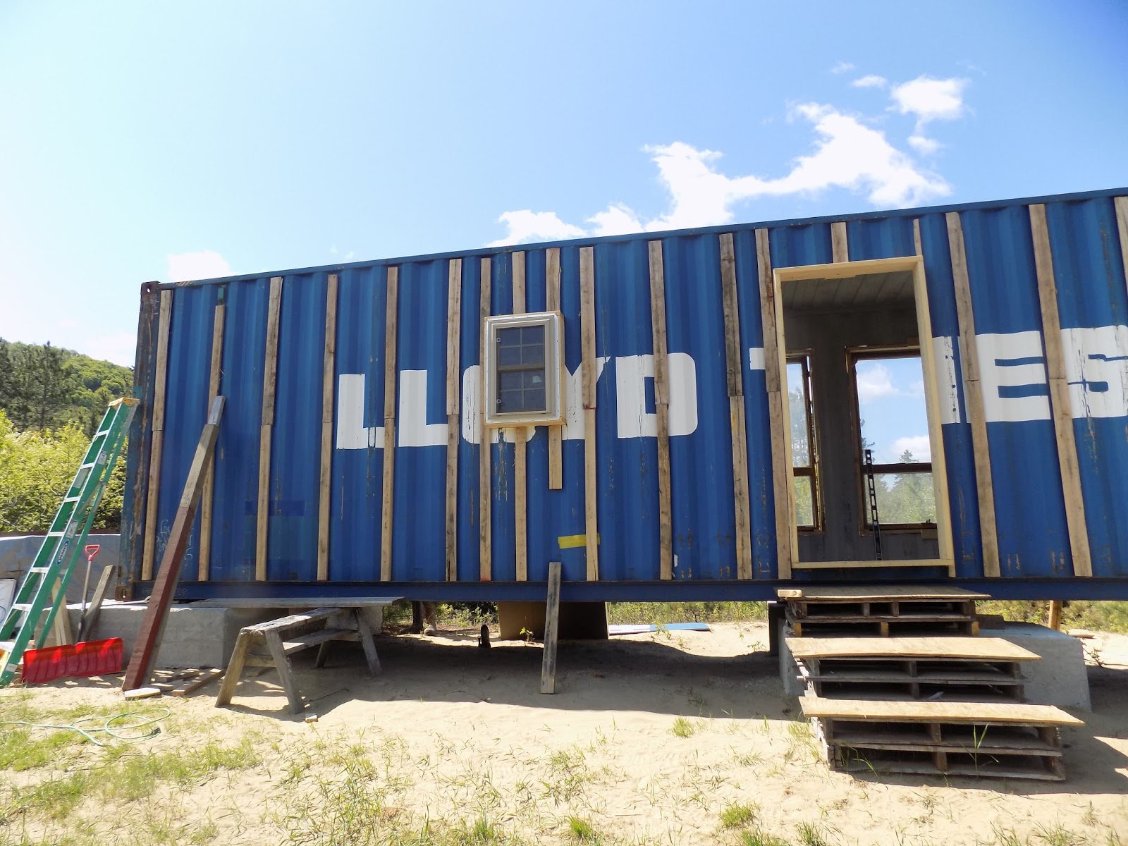 Intermodal House: Strapping on, Windows in, Insulation, Siding Mostly on