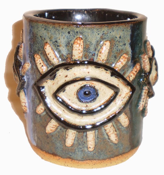 This is a slab-built pot/cup/mug with three large eyes. The "eyelashes ...