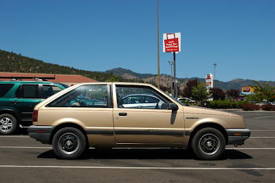 OLD PARKED CARS.: 1986 Chevrolet Spectrum 2-door hatchback.