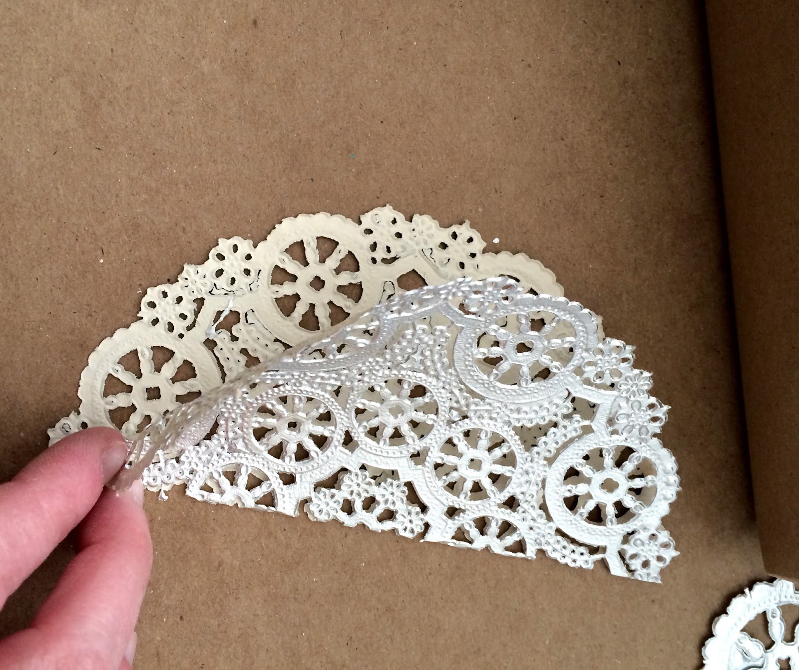 Fold the doily in half making sure to match the pattern for the neatest ...