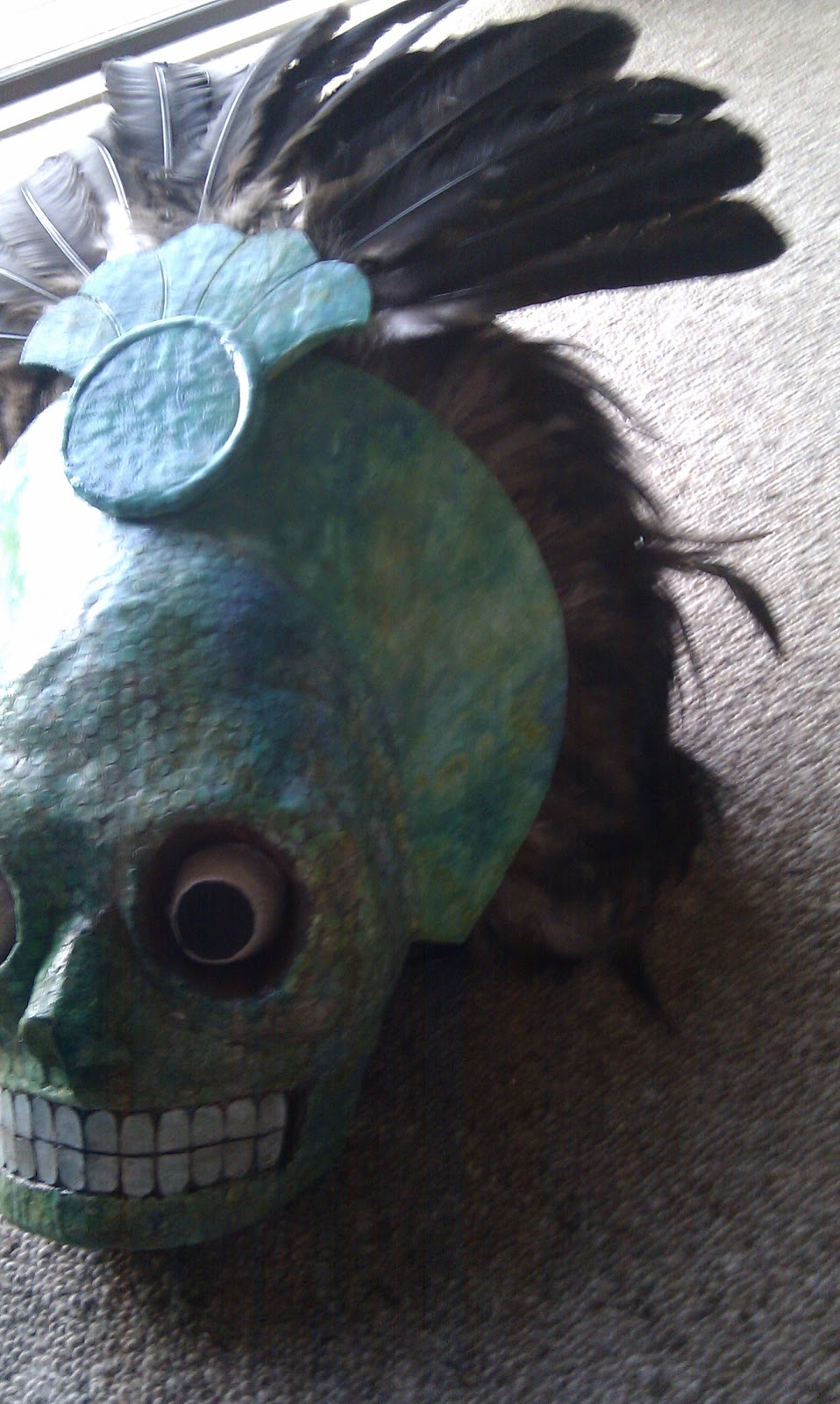 Mayan mask with feathers