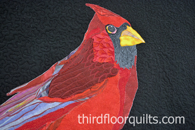 a red cardinal on black wool