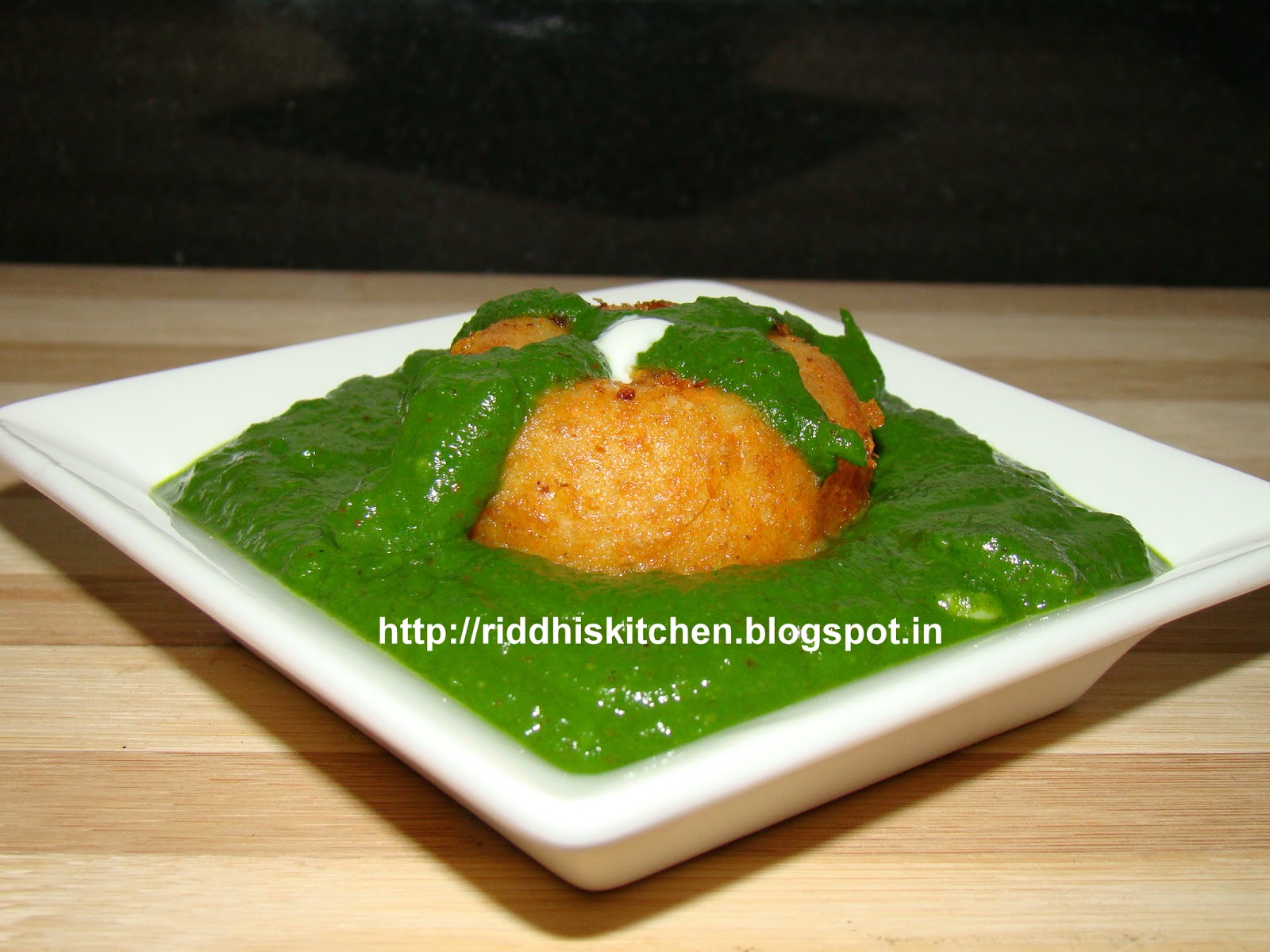 Potato Paneer Tikki In Spinach Gravy.