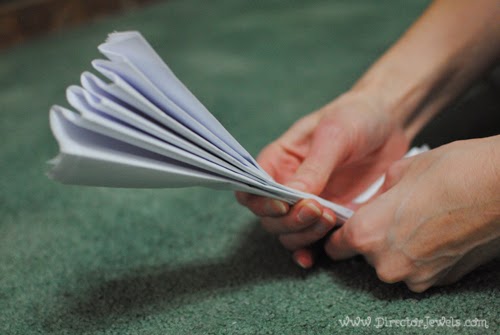 3. Once all layers are folded, you will have one long strip. Smooth out ...