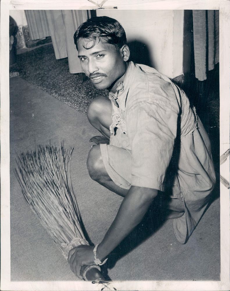 One of India's "untouchables" holds the broom he uses in sweeping out ...