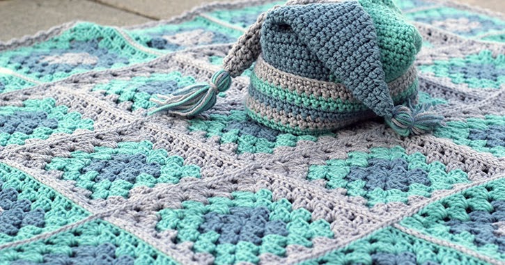 A granny square blanket with a jester hat