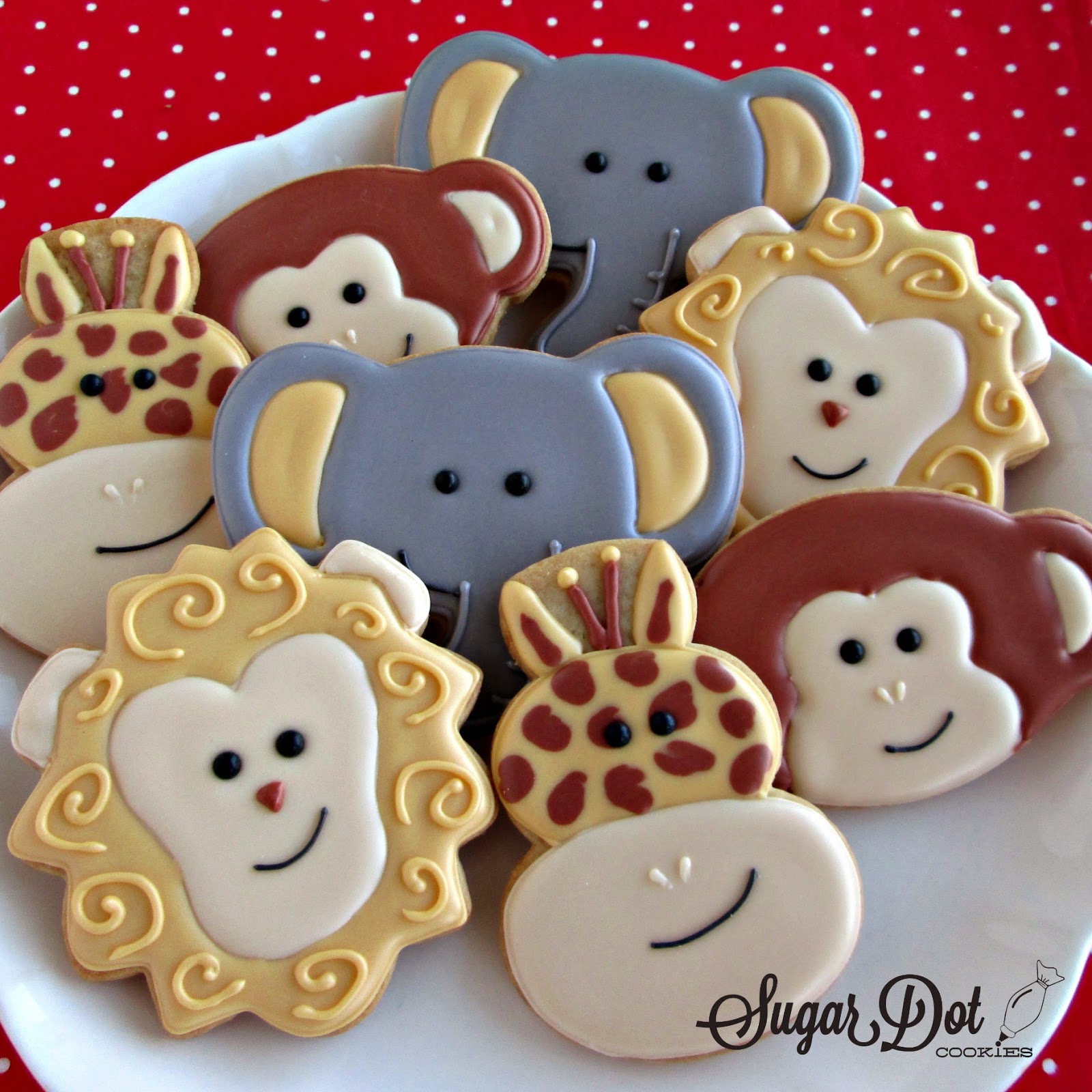 Lion, giraffe, monkey and elephant cookies for a baby shower.