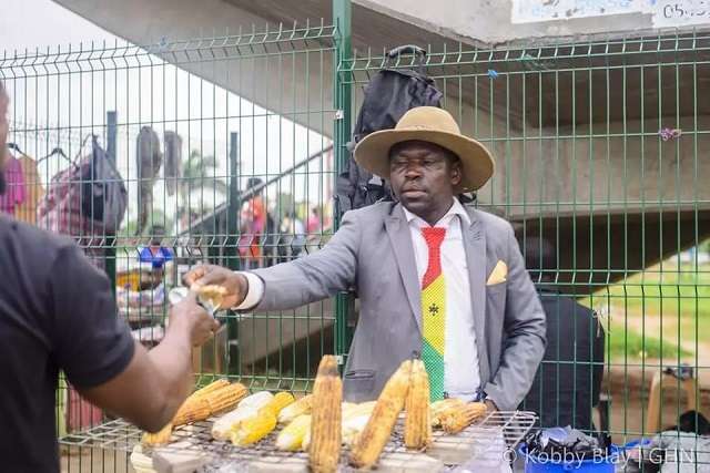Ghanaian man sells roaster corn in suit and tie | AfricanEagle